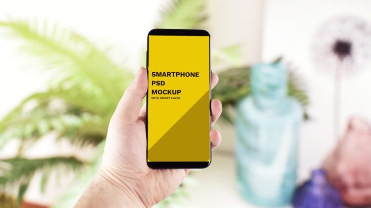A Person Holding an iPhone Free Mockup PSD - PsFiles