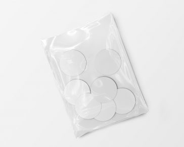 Free Round Stickers Mockup on Plastic Cover - PsFiles
