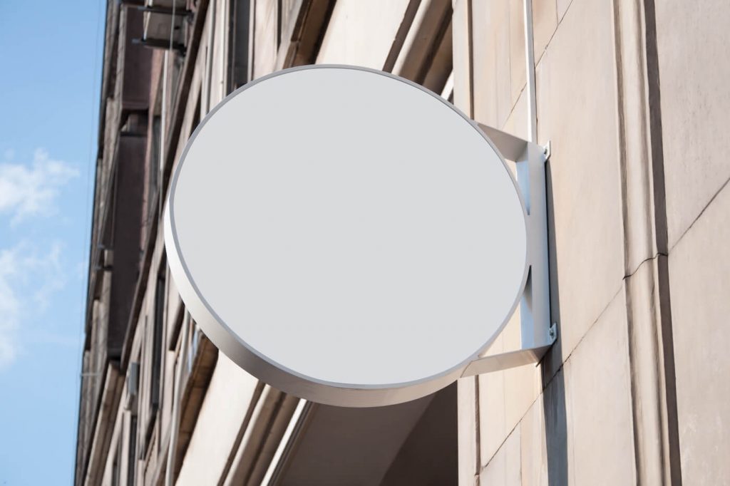 Free Round Metal Sign Mockup on Building Wall mounted - PsFiles