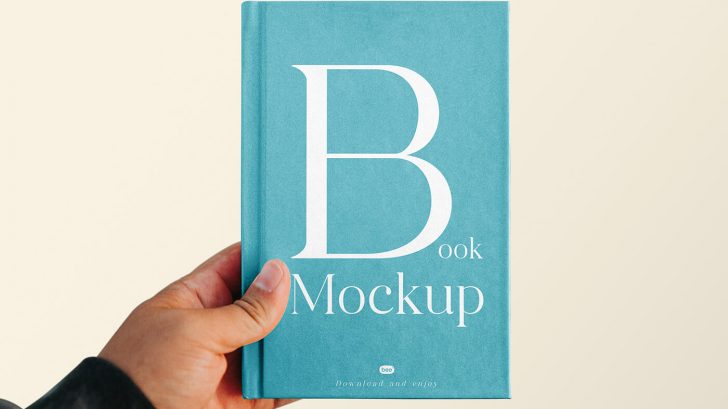 Free Hand Holding Hardcover Book Mockup Free PSD - PsFiles